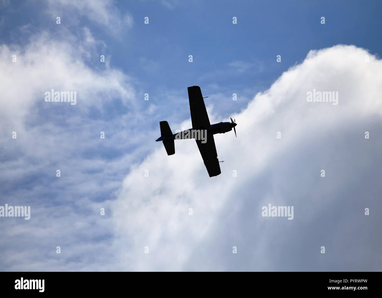 Retro piston airplane with propeller in flight on the background of ...