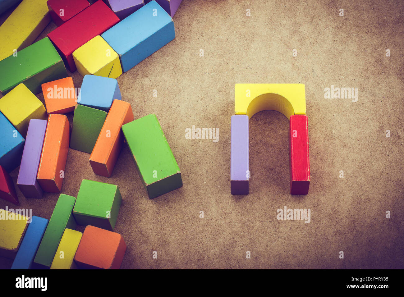 Colorful building blocks on a brown background Stock Photo - Alamy