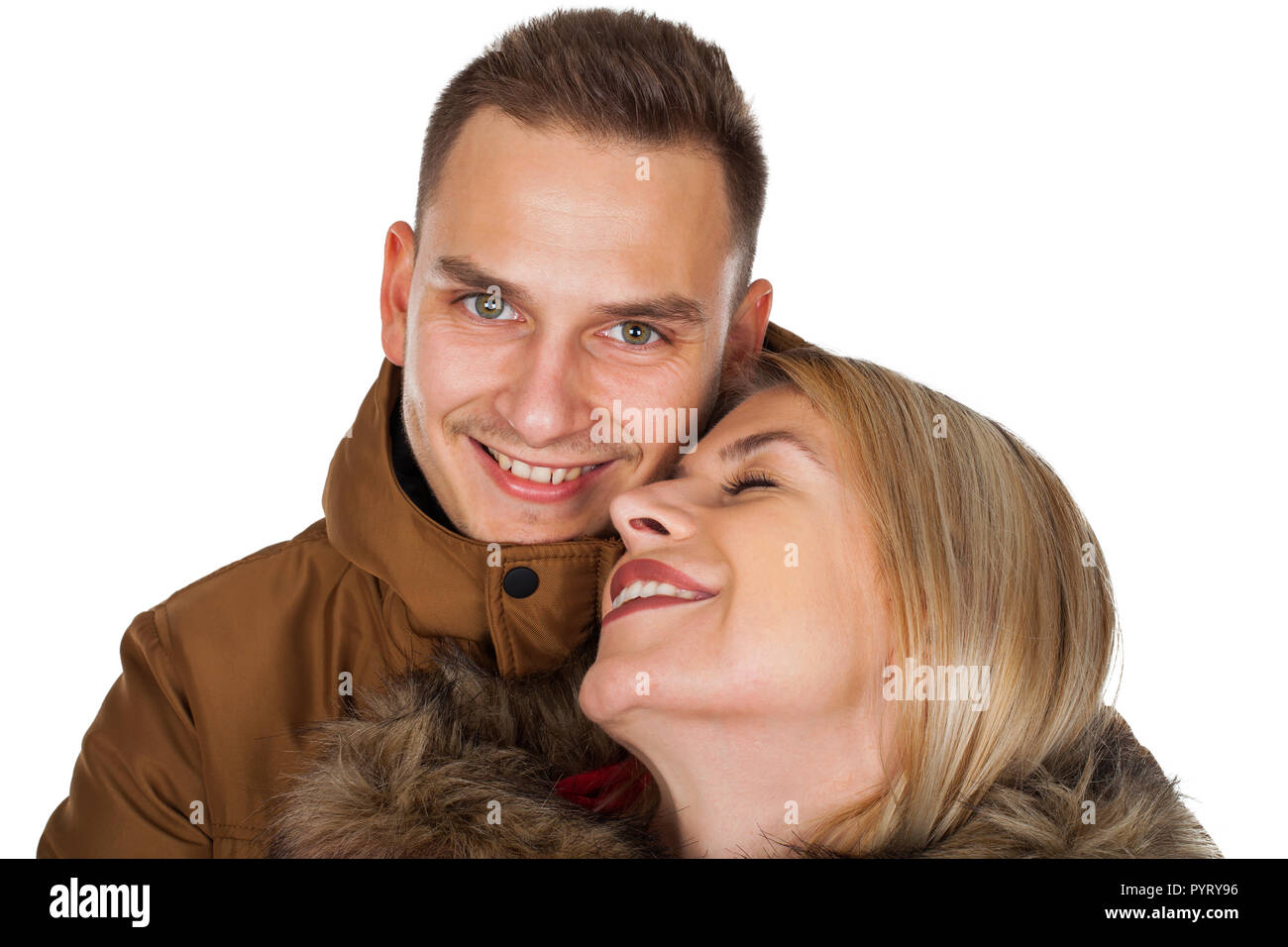 Young couple wearing winter clothing and cuddling on isolated ...