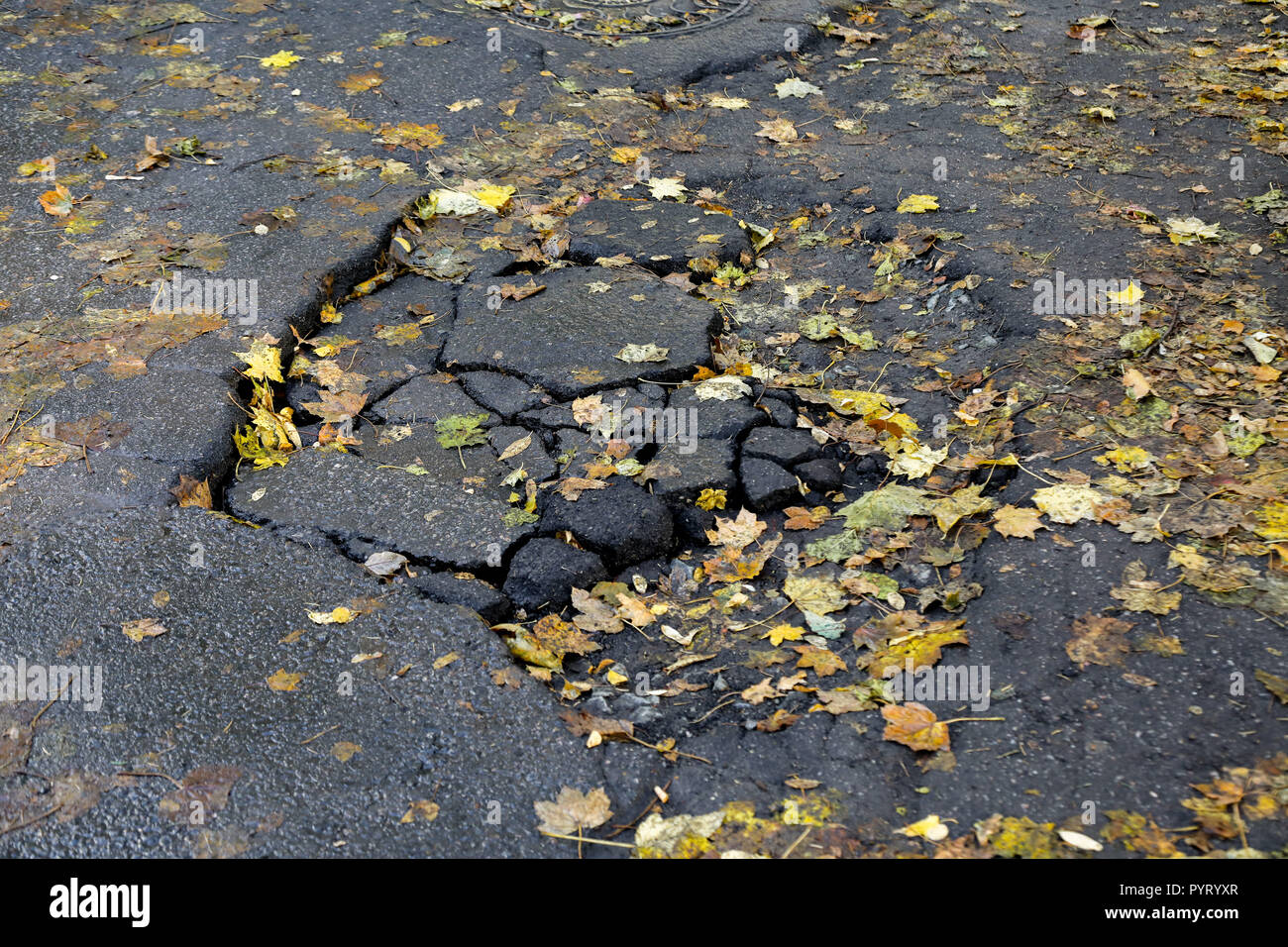 large pit with stones on the asphalt road Stock Photo - Alamy