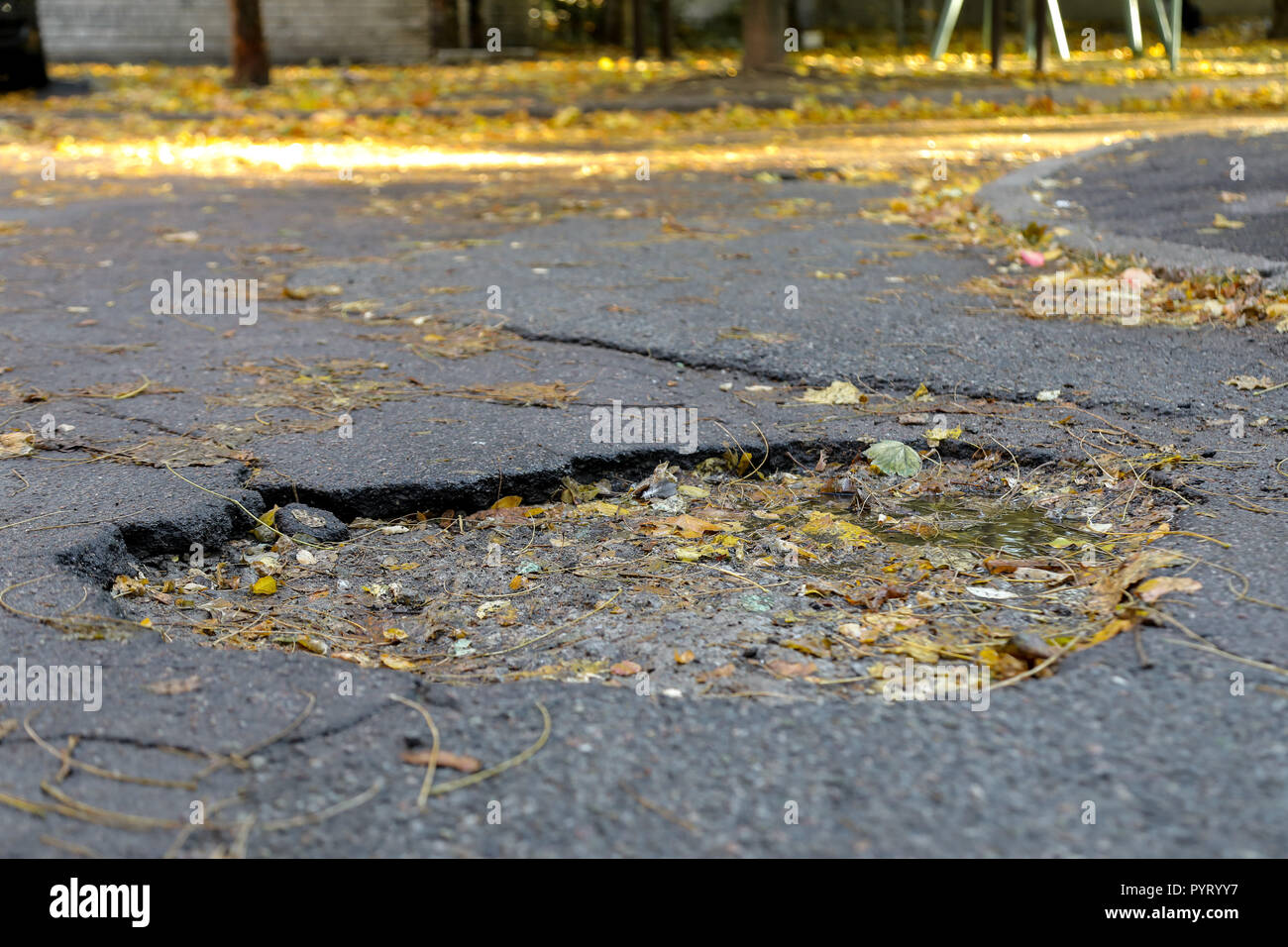 large pit with stones on the asphalt road Stock Photo - Alamy