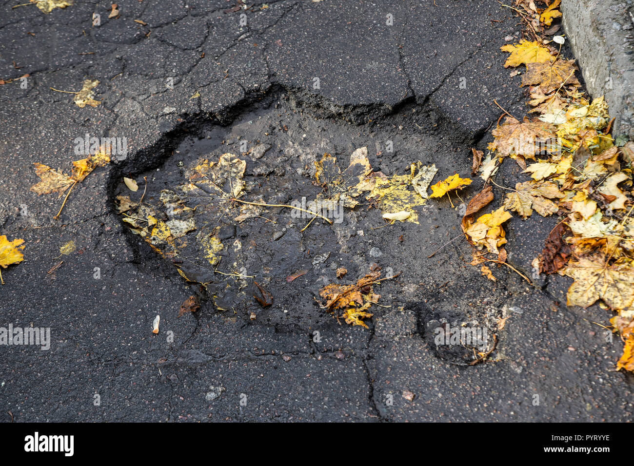 large pit with stones on the asphalt road Stock Photo - Alamy