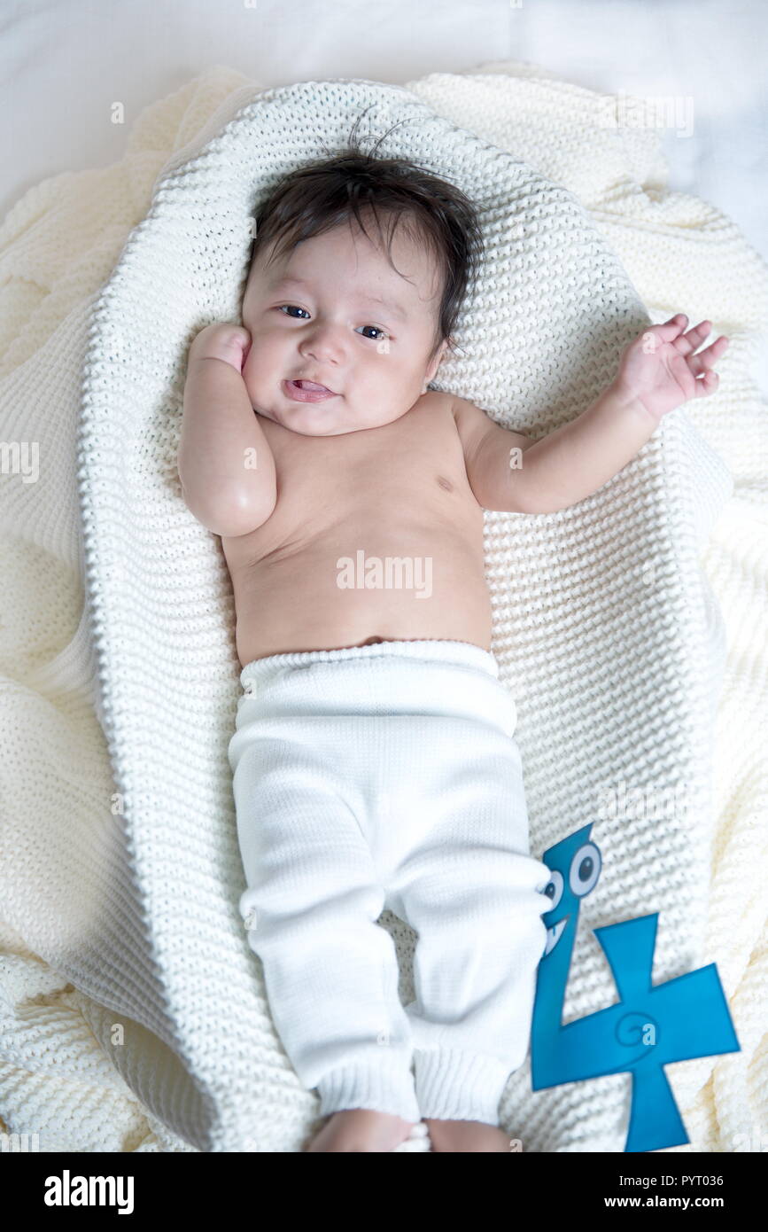 Cute little four month old baby in the Basket with white background on ...