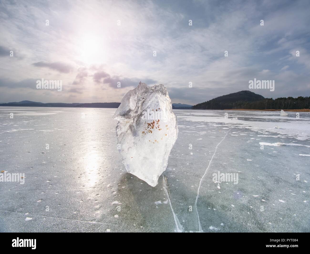 Ice breaking. Floe on frozen lake with sunset sky background Stock ...