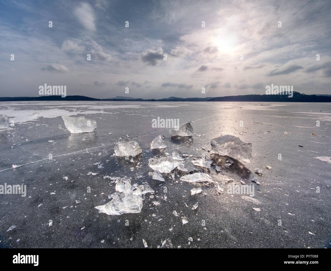 Ice breaking. Floe on frozen lake with sunset sky background Stock ...
