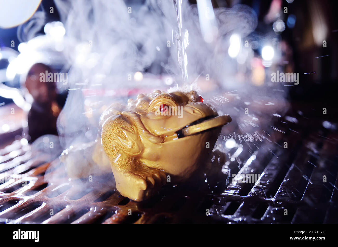 A tea figurine - a three-lipped toad with a coin in his mouth Stock ...