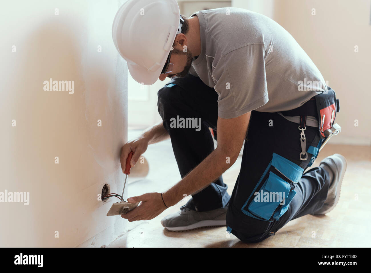 Professional electrician installing sockets using a screwdriver: home ...
