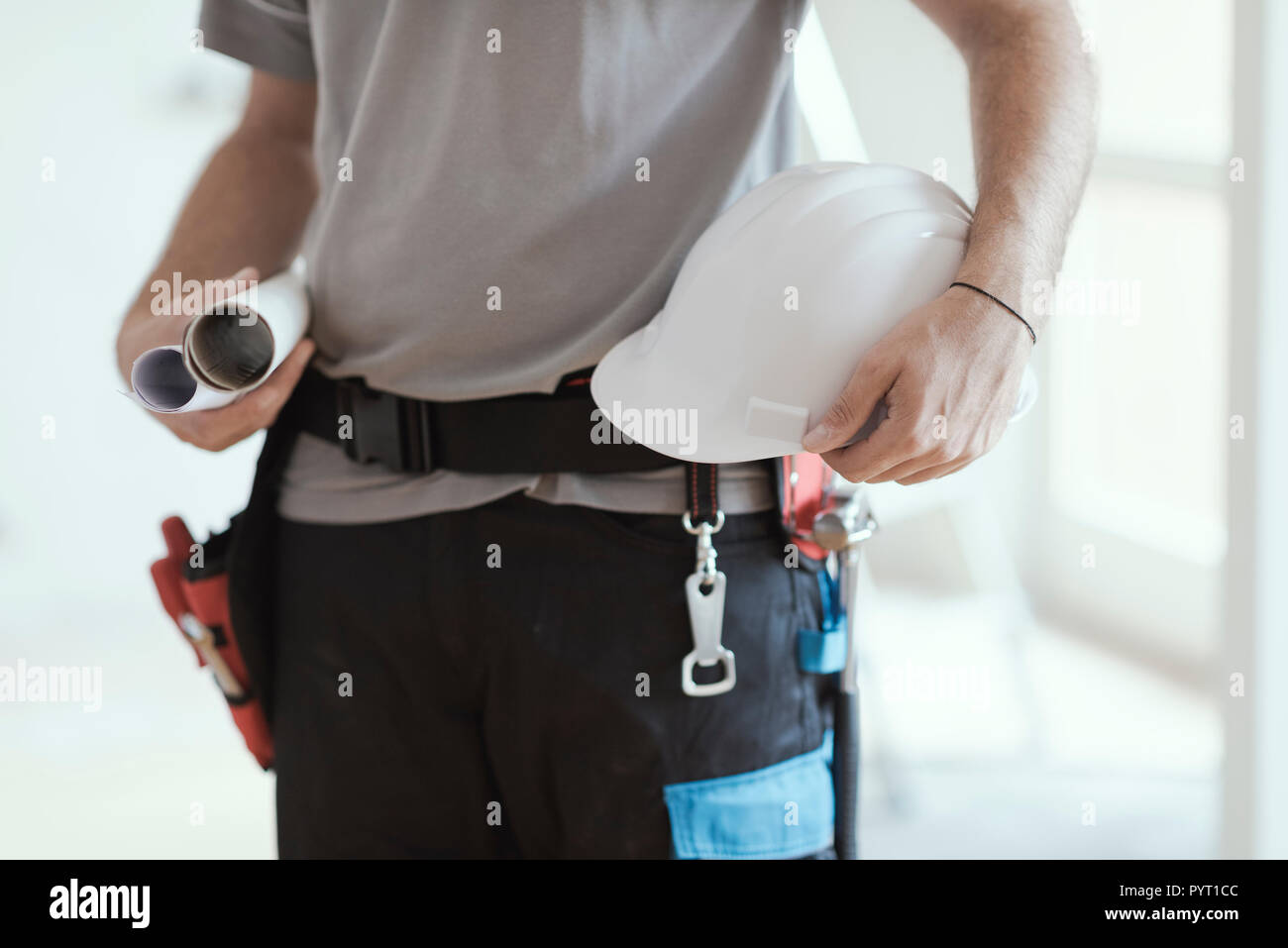 Professional construction engineer holding paper rolls and a safety ...