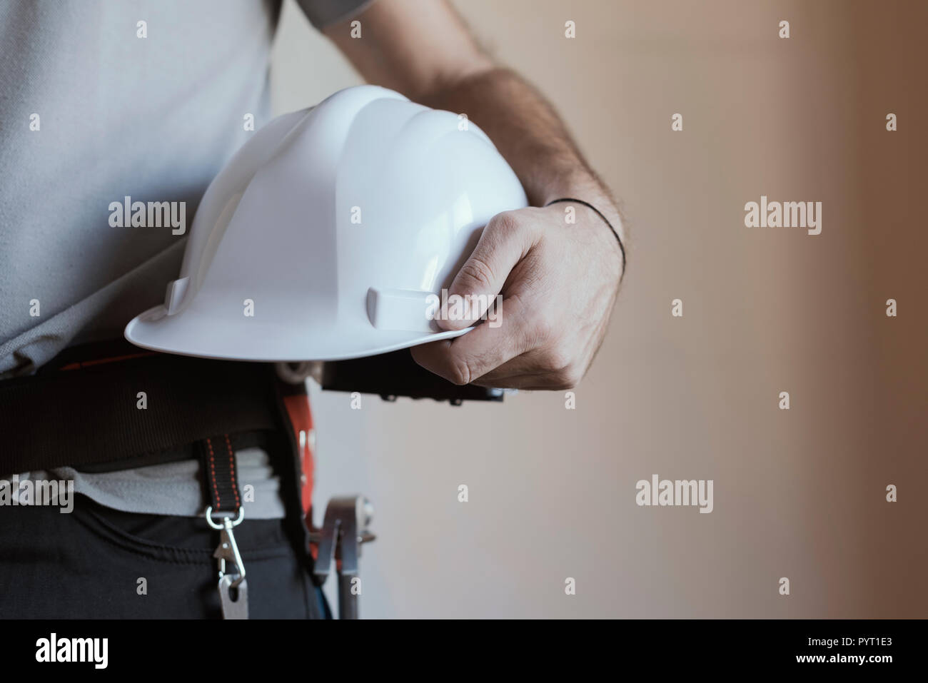 Construction worker holding a safety helmet: construction and workplace ...