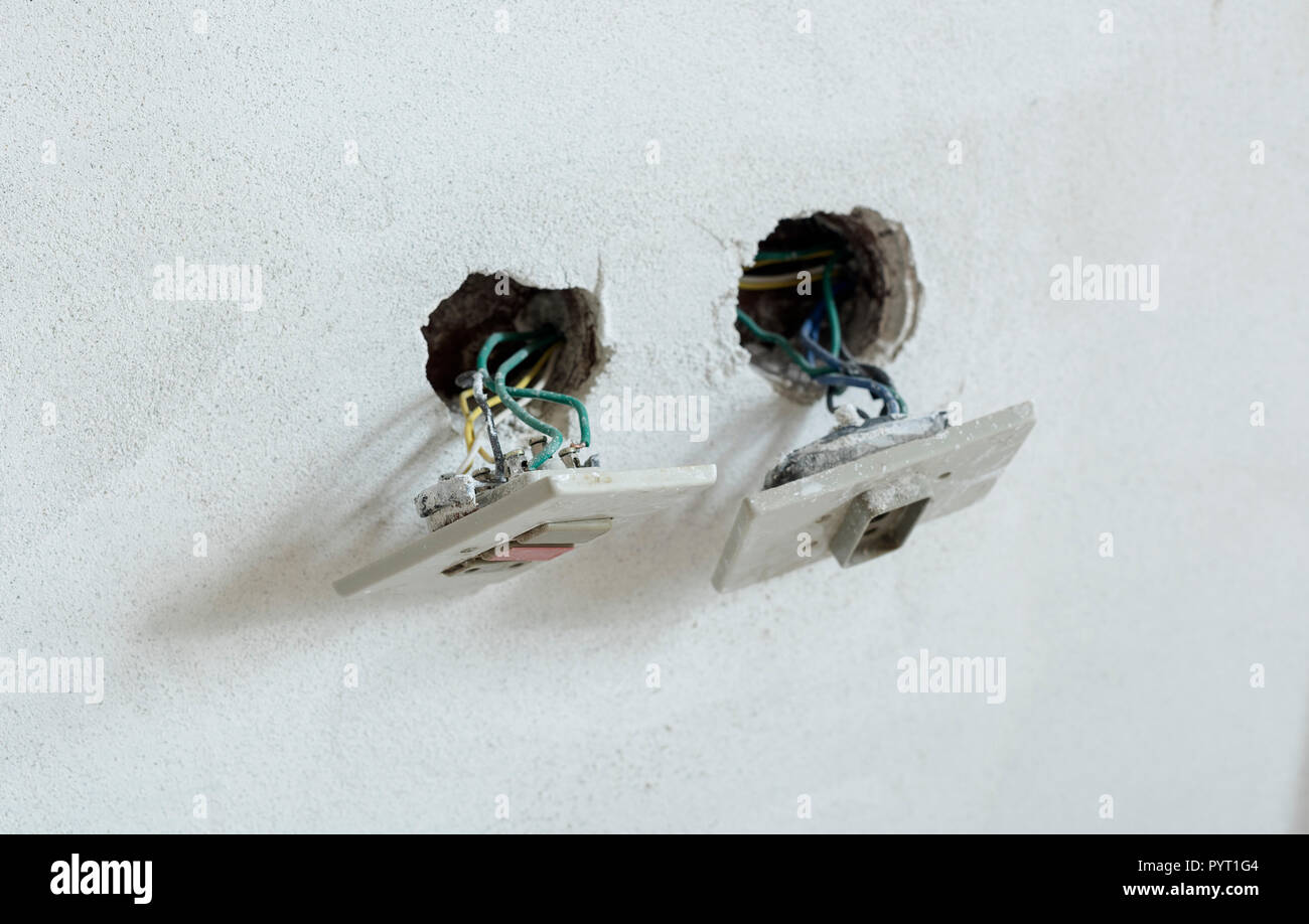 Wall socket installation and renovation, close up of old socket and ...