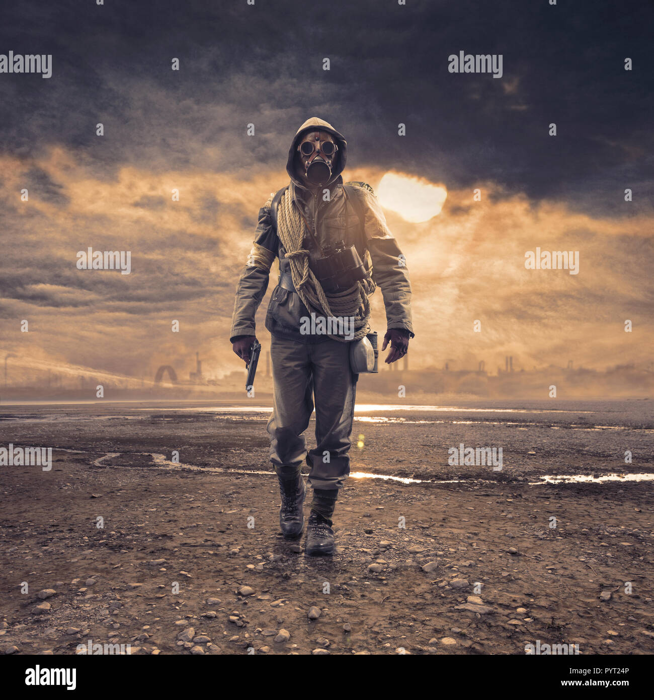Brave soldier with gas mask and gun walking in a polluted post atomic ...