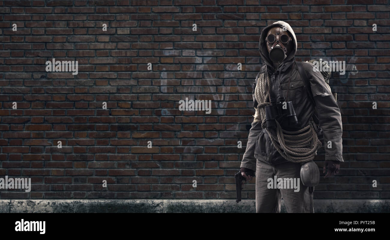 Brave post apocalyptic survivor with gas mask and gun: environmental ...