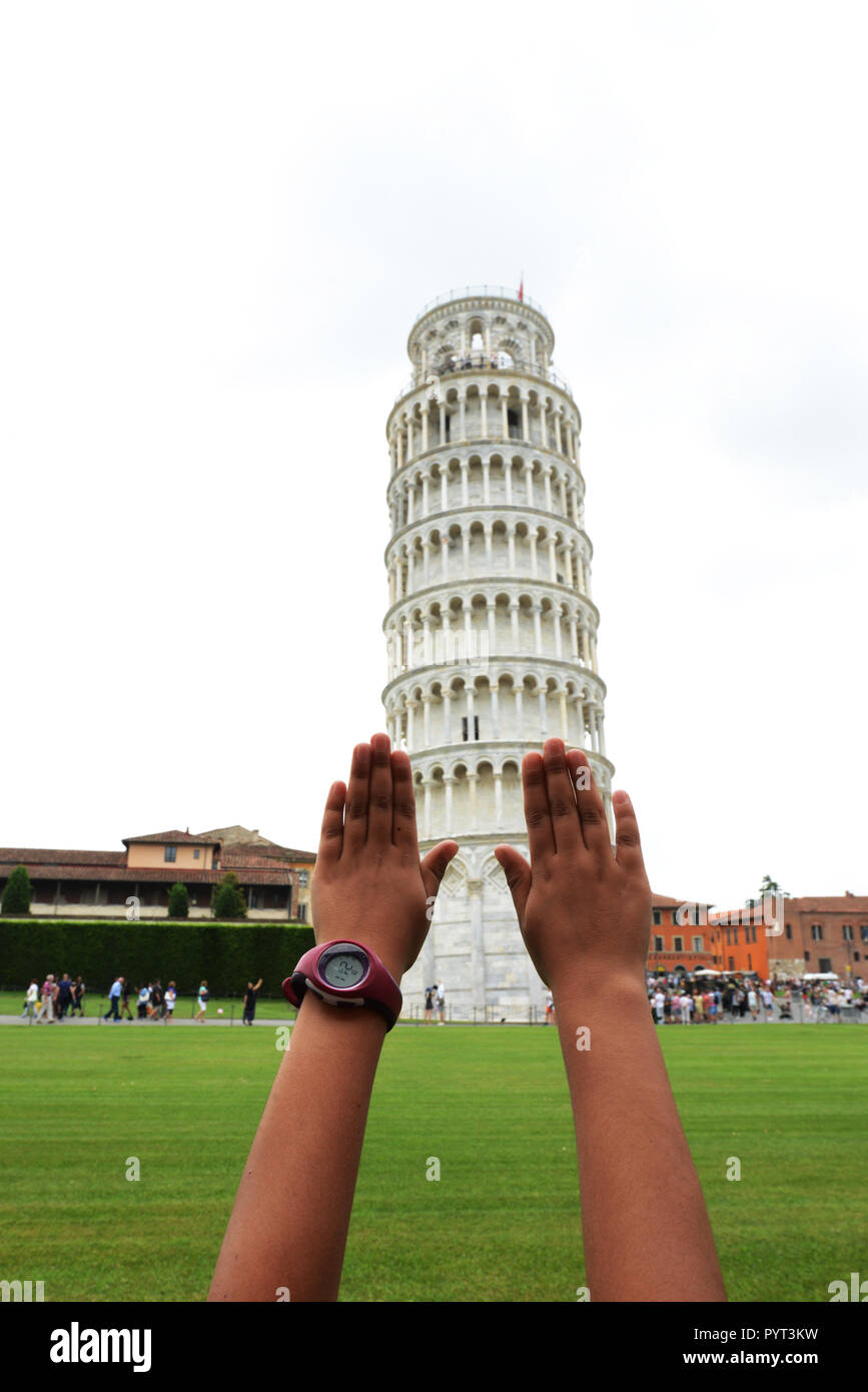 Pushing the leaning tower of Pisa in Tuscany, Italy Stock Photo - Alamy