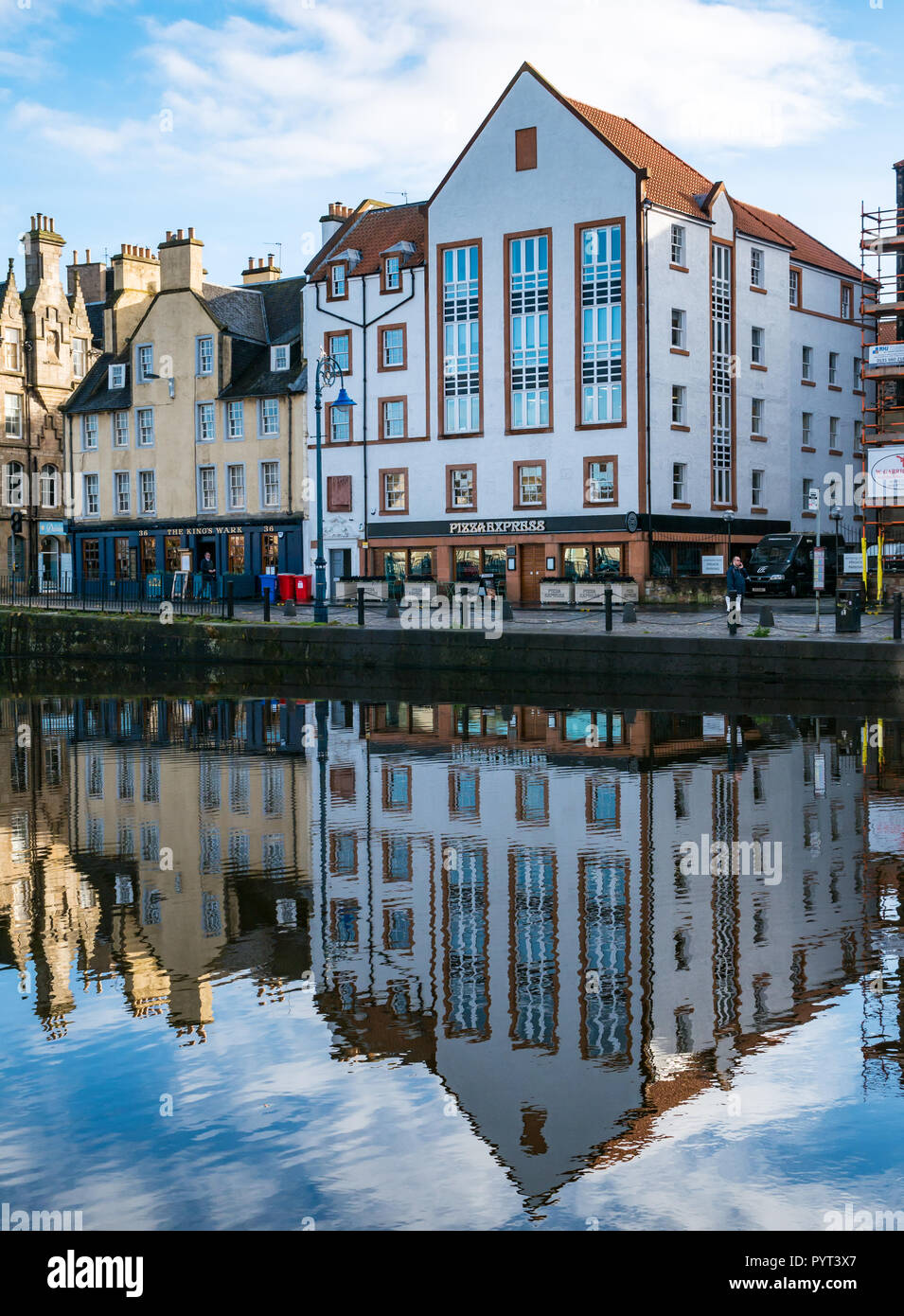 Old buildings reflected in Water of Leith with Pizza Express restaurant ...