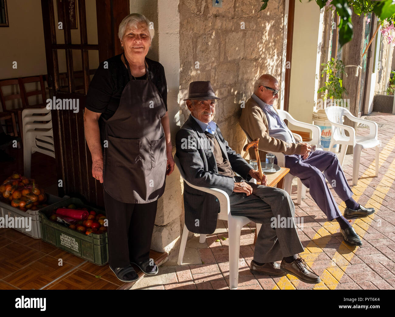 Portrait a group of elderly Cypriot residents sitting outside a taverna ...