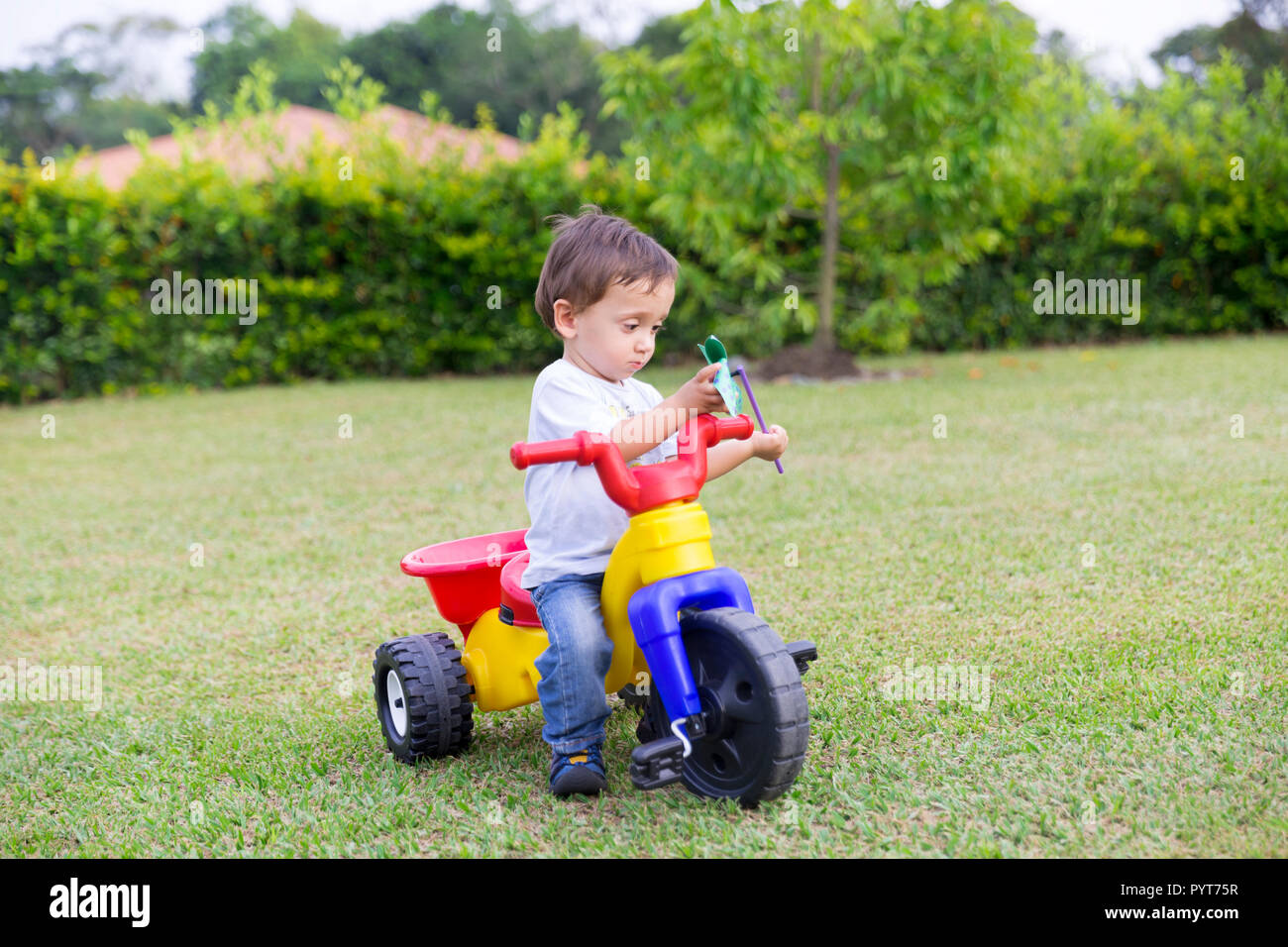 Happy Little Boy Driving His Toy In The Park Stock Photo - Alamy