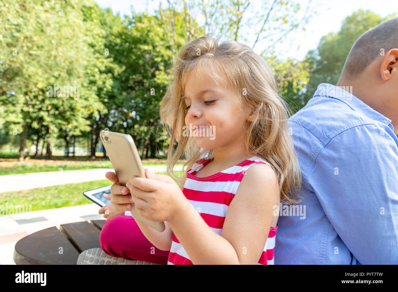 Group of busy kids looking at their phones texting sms and playing ...