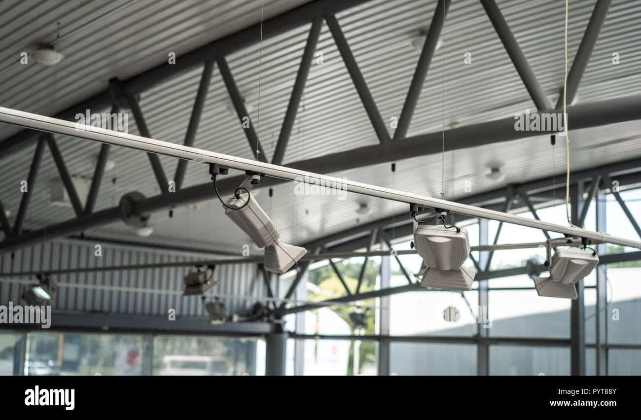 Spotlight hang from the ceiling in the exhibition hall Stock Photo - Alamy
