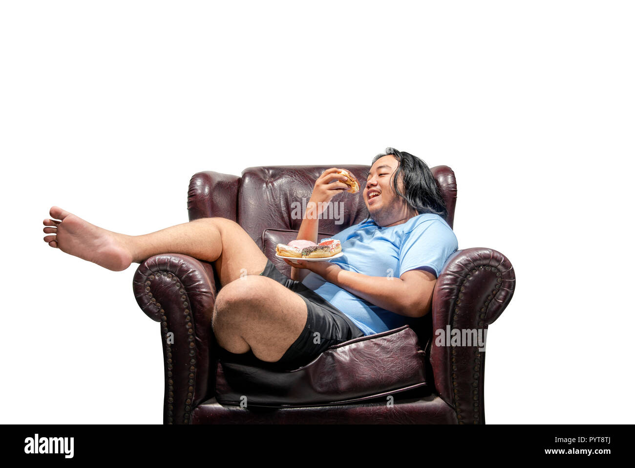 Happy asian fat man snacking donuts on plate in the couch isolated over ...