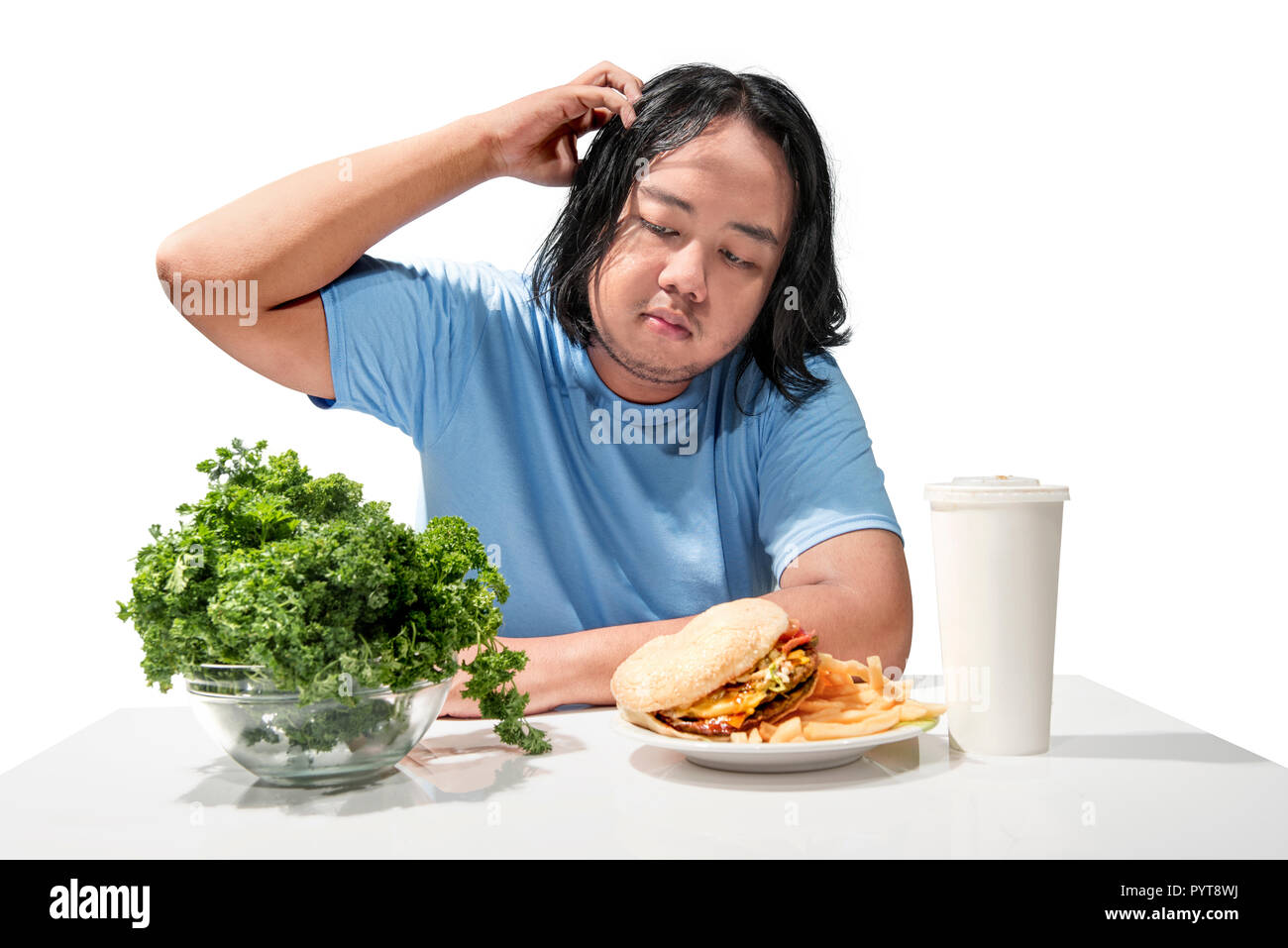 Young asian fat man confused choosing between fast food or healthy food ...
