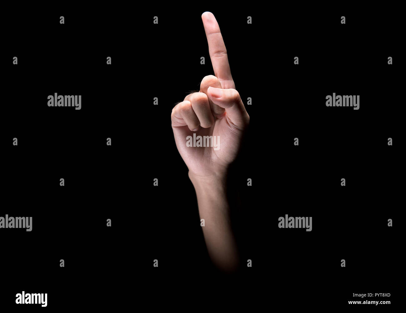 Male hands with pointing gesture or one finger sign over dark ...