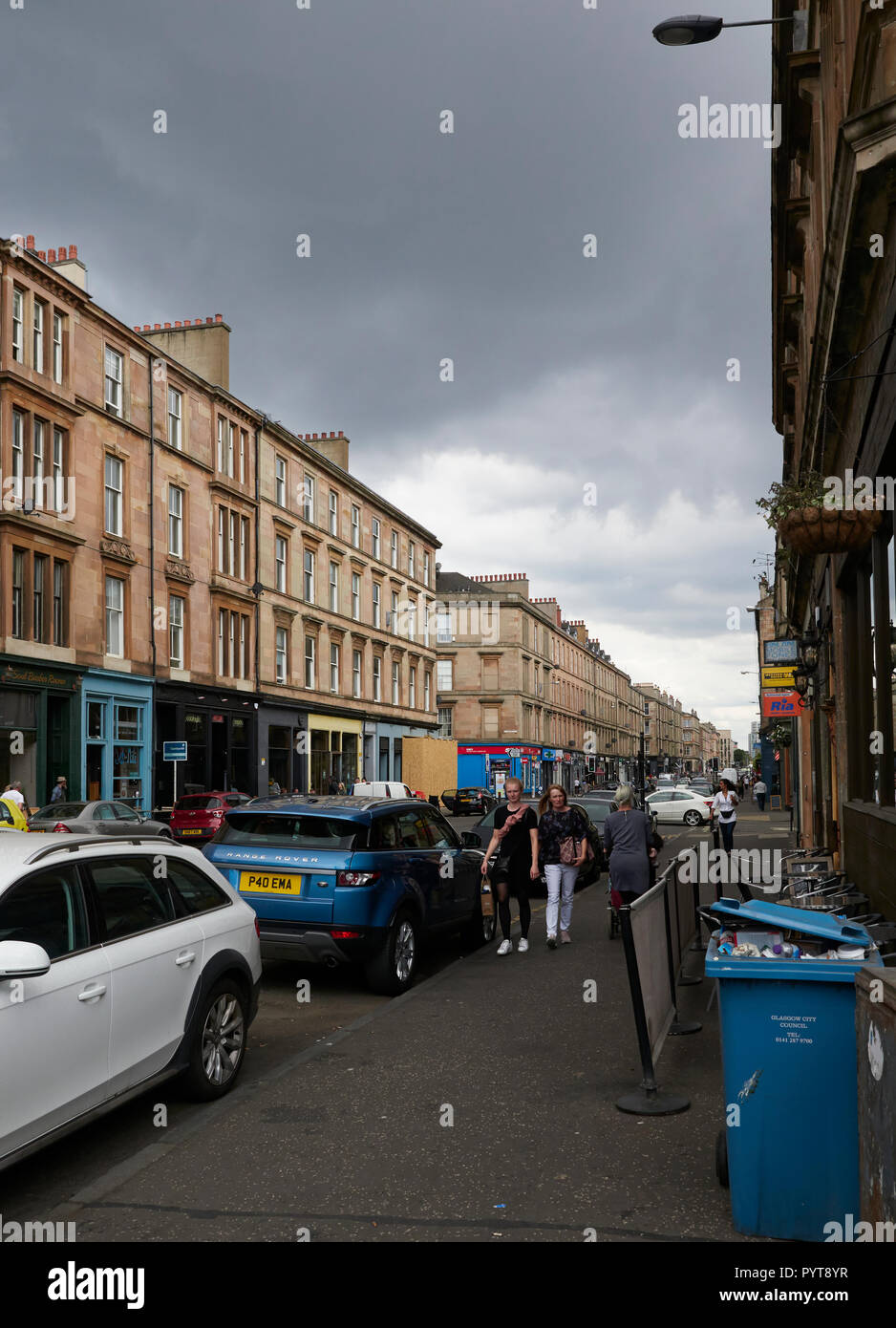 A busy Street in Glasgow, Scotland with People walking down the wide ...
