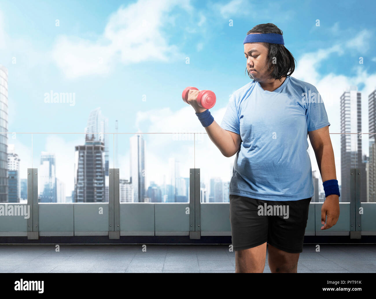 Asian fat man doing exercise with dumbbell on terrace gym. Fat man diet ...