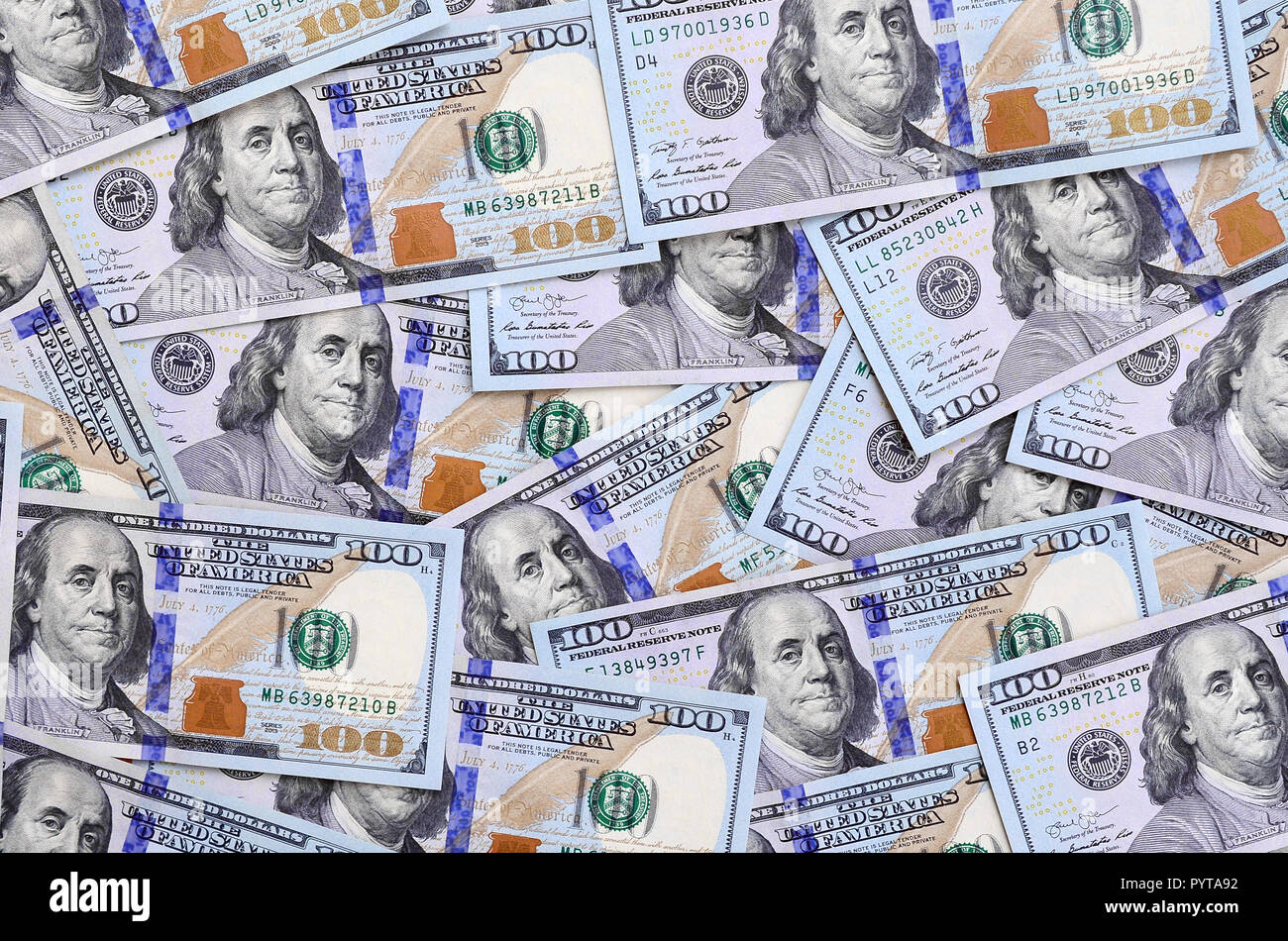 A large number of US dollar bills of a new design with a blue stripe in ...