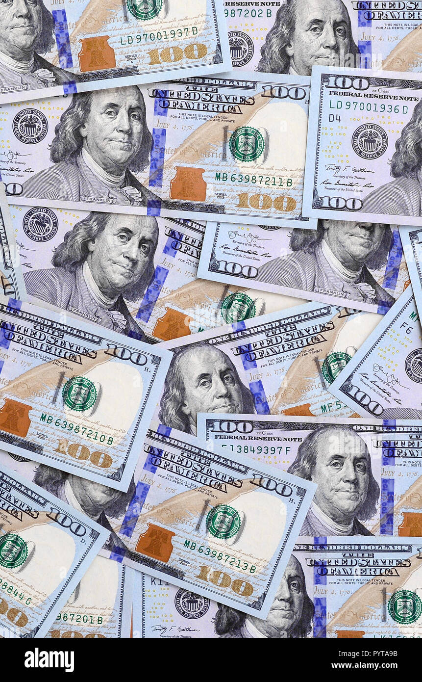A large number of US dollar bills of a new design with a blue stripe in ...