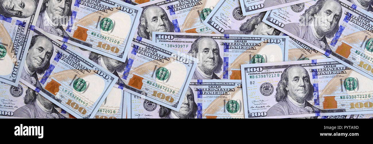 A large number of US dollar bills of a new design with a blue stripe in ...