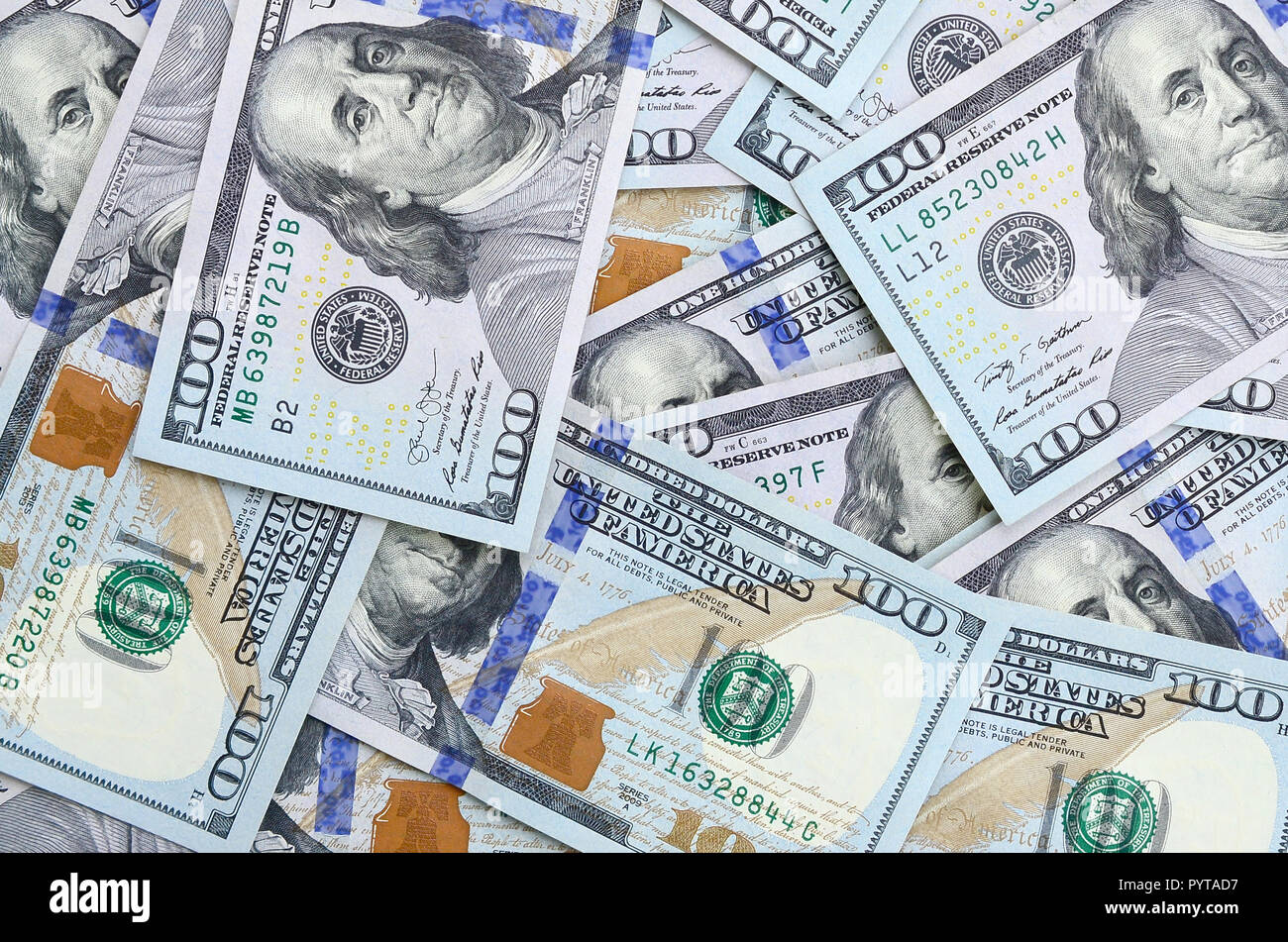 A large number of US dollar bills of a new design with a blue stripe in ...