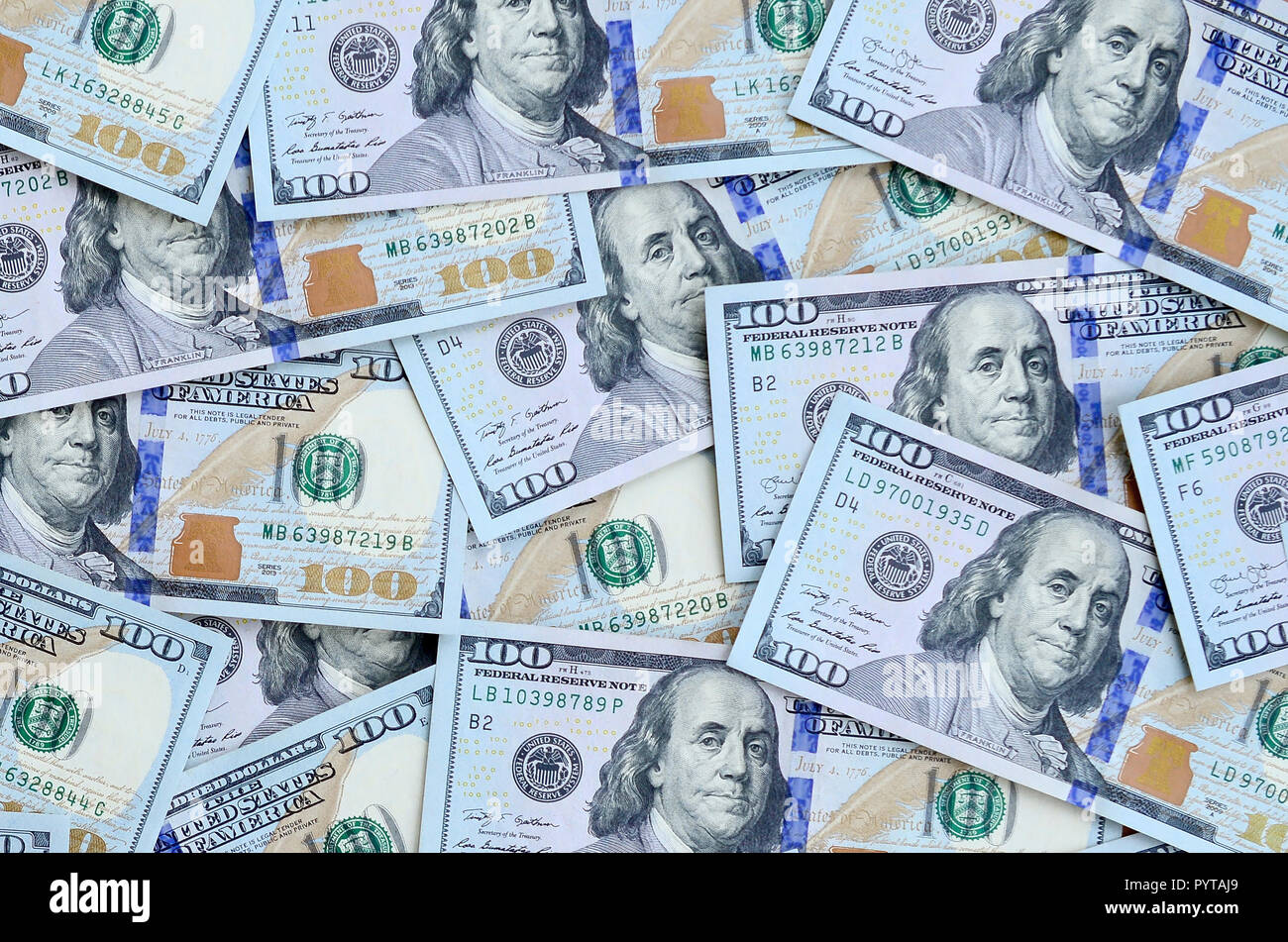 A large number of US dollar bills of a new design with a blue stripe in ...