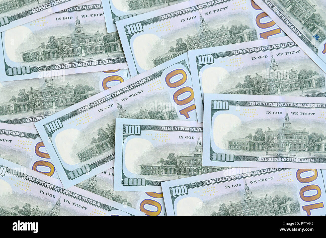 A large number of US dollar bills of a new design with a blue stripe in ...