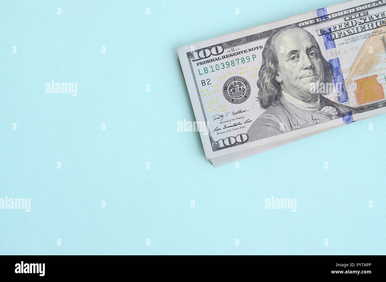 US dollar bills of a new design with a blue stripe in the middle is ...