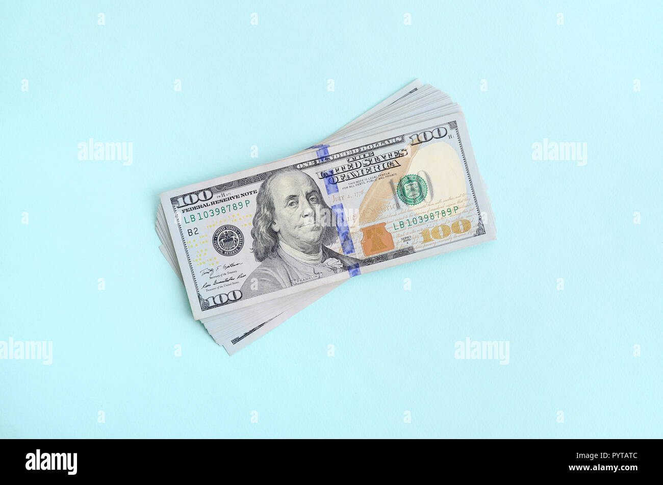 US dollar bills of a new design with a blue stripe in the middle is ...