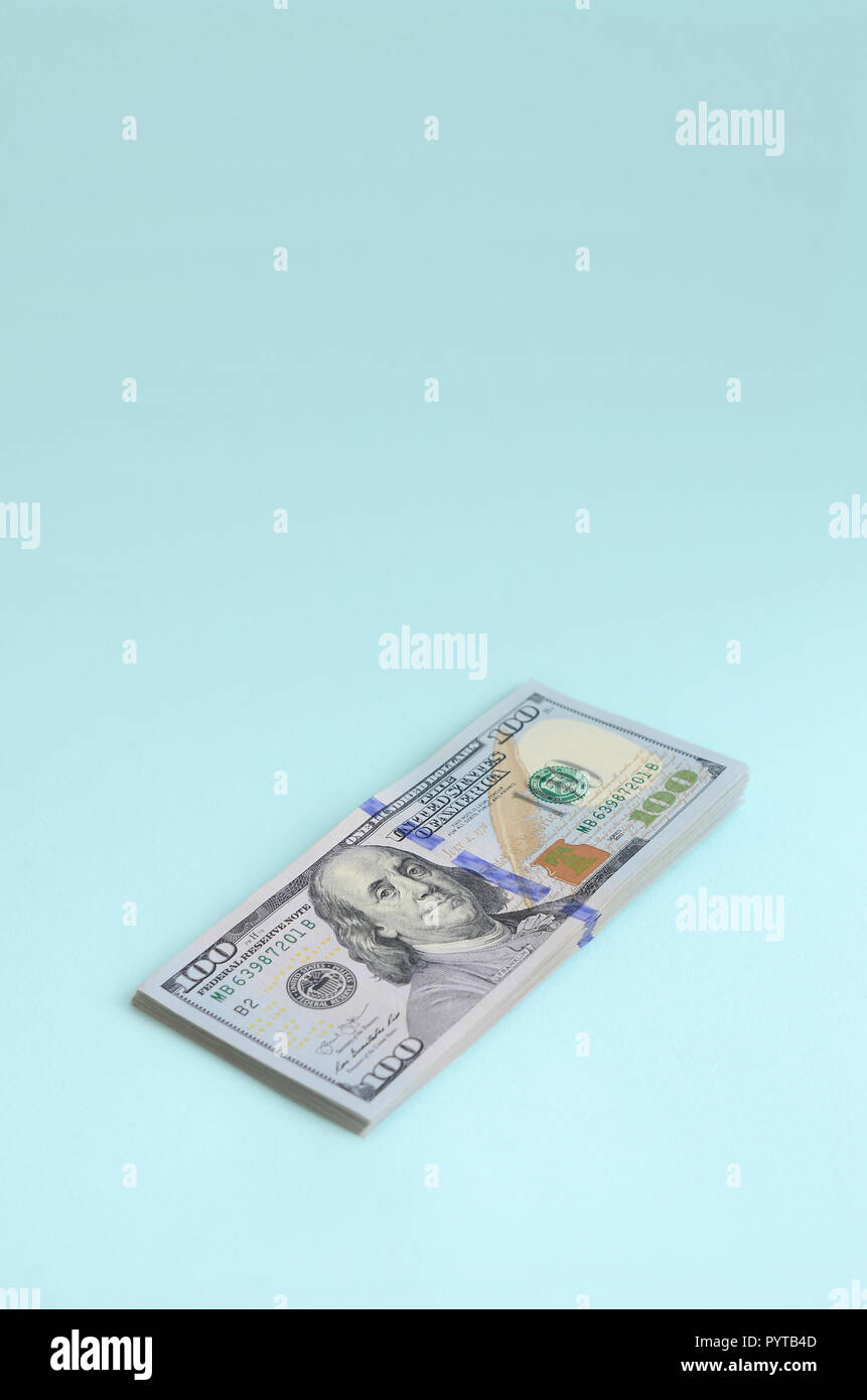 US dollar bills of a new design with a blue stripe in the middle is ...