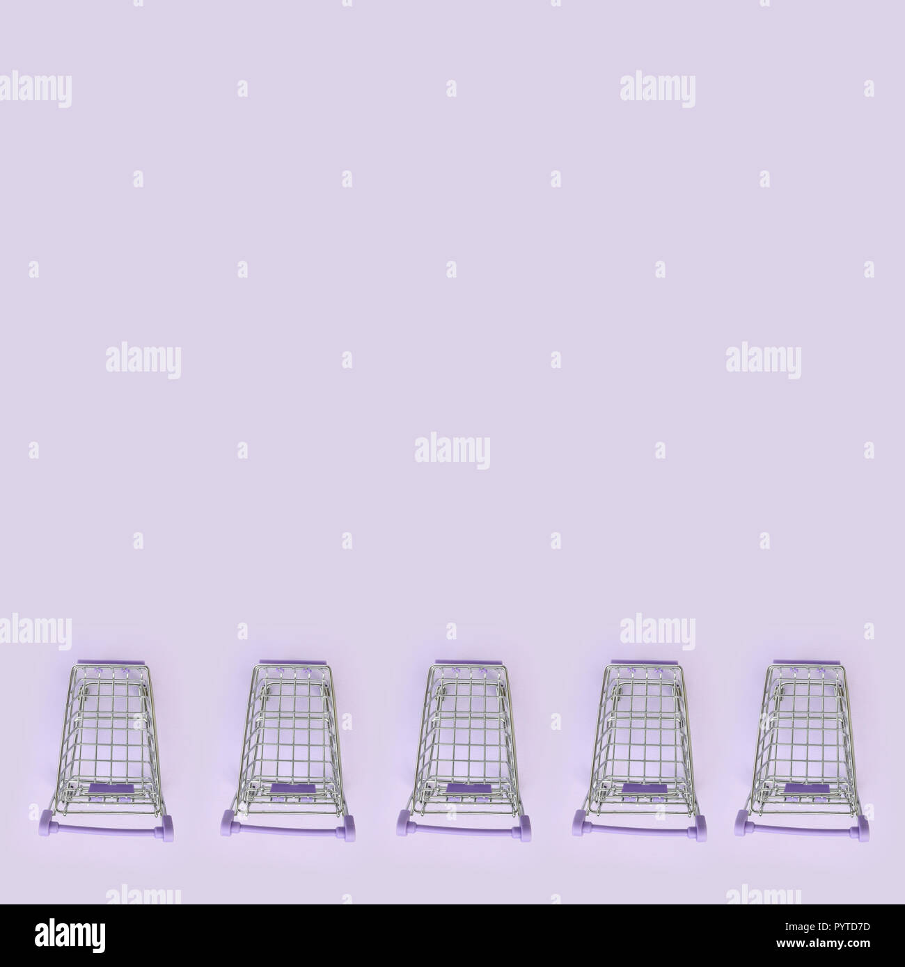 Pattern of many small shopping carts on a violet background. Minimalism ...