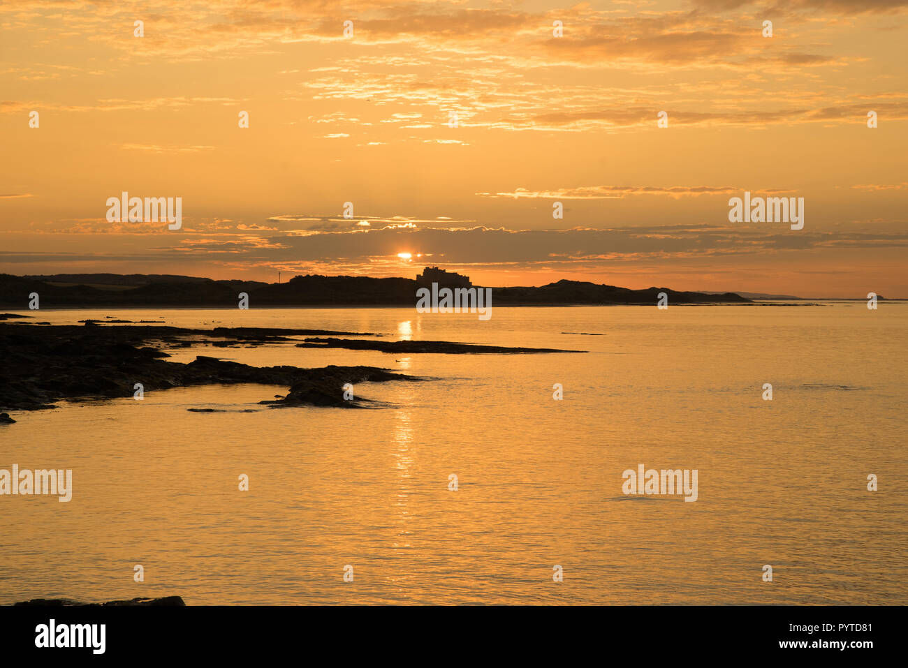 Sunset at Bamburgh Castle from Seahouses Stock Photo - Alamy