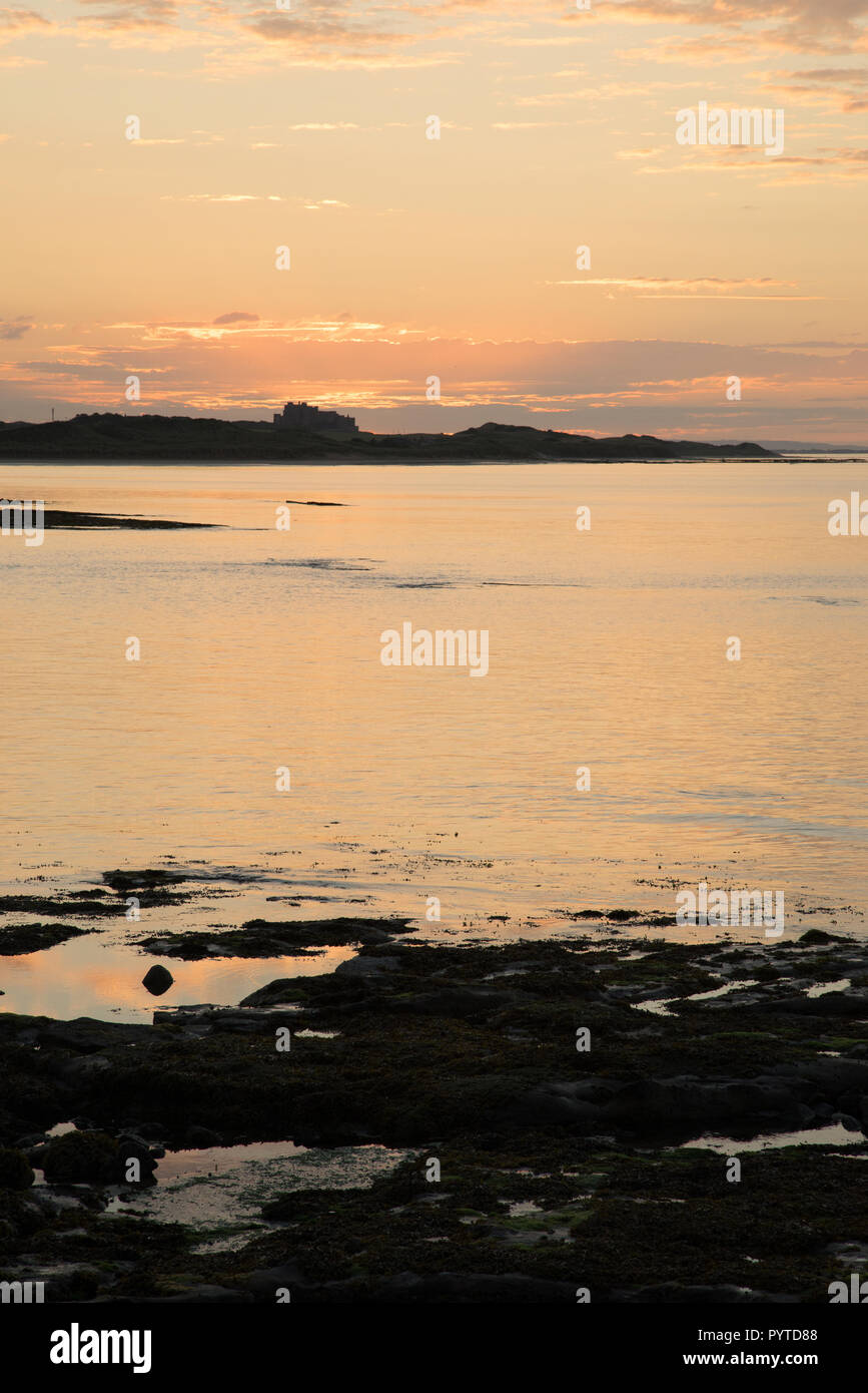 Sunset at Bamburgh Castle from Seahouses Stock Photo - Alamy