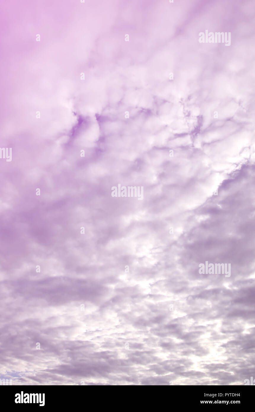 A blue cloudy sky with many small clouds blocking the sun Stock Photo ...