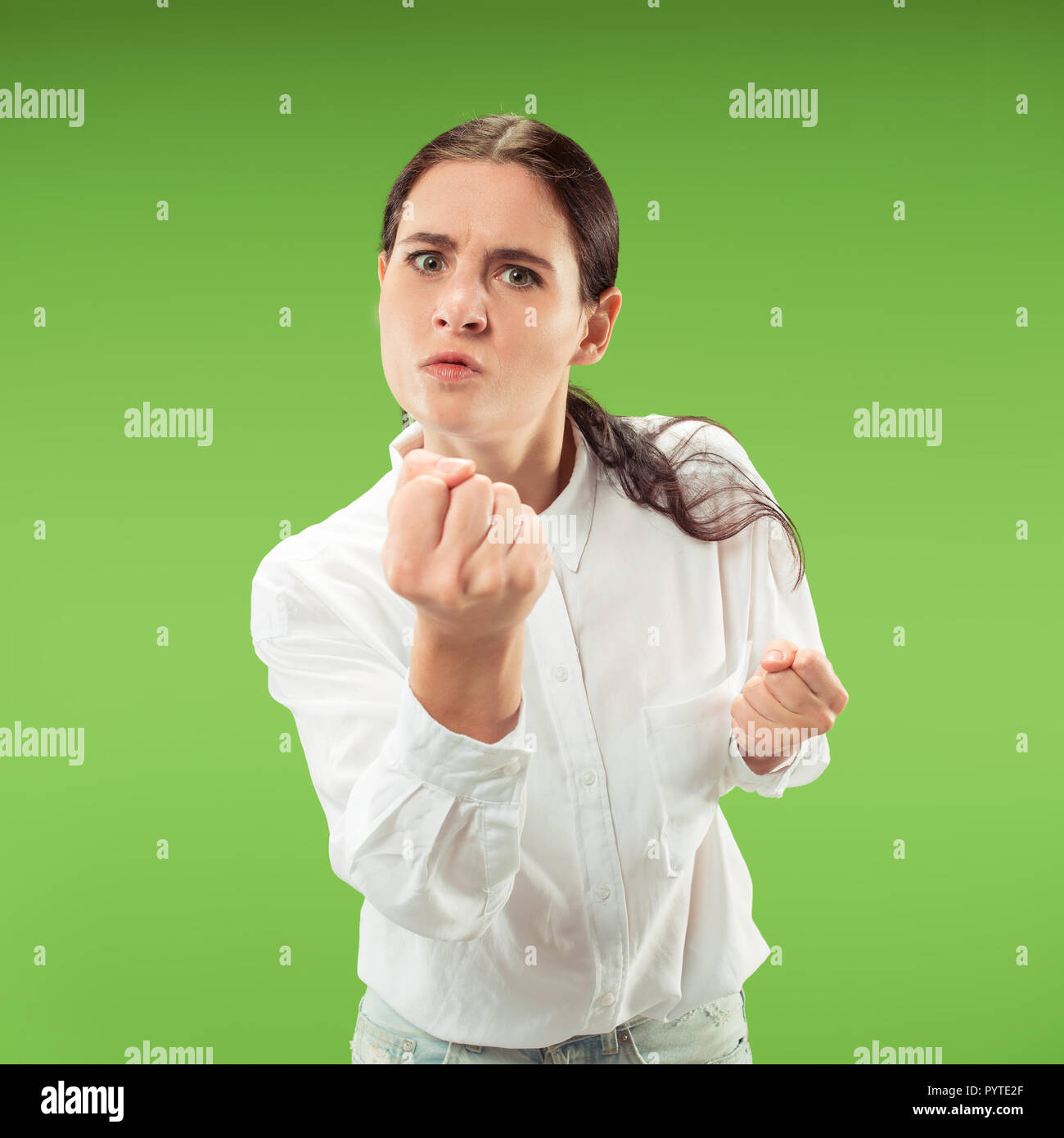 Angry woman looking at camera. Aggressive business woman standing ...