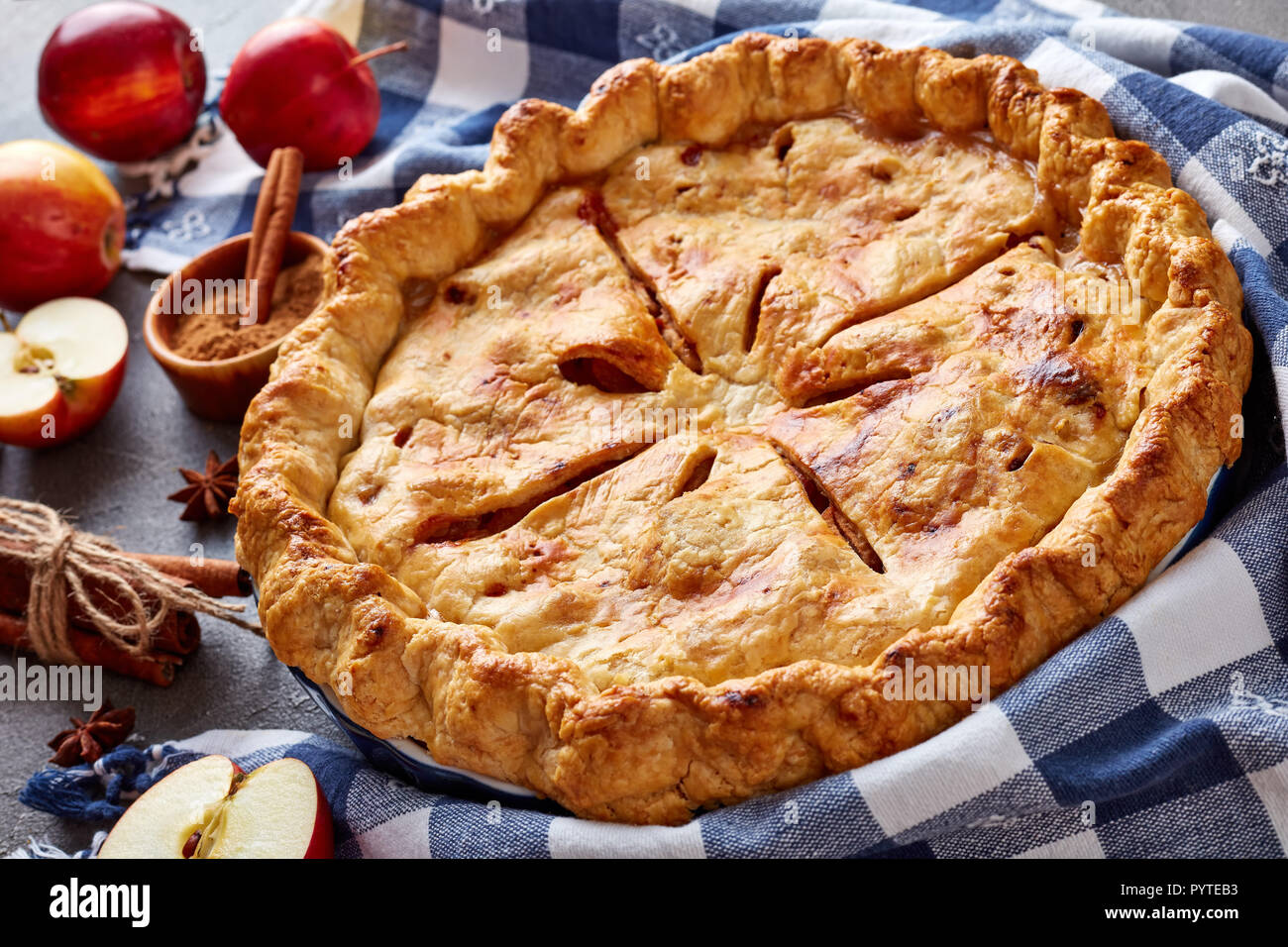 American apple pie on a concrete table with kitchen towel and ...