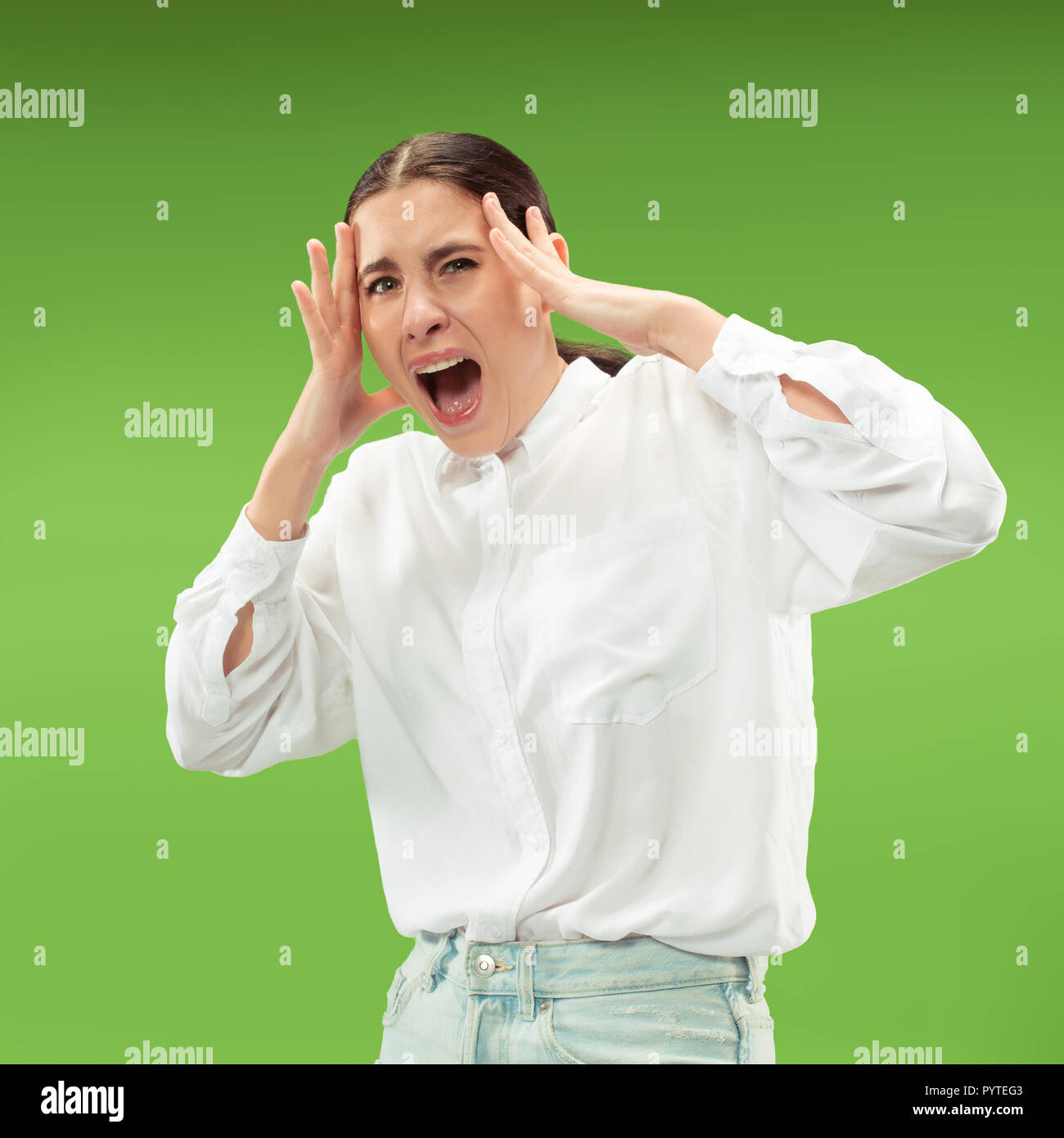 Screaming, hate, rage. Crying emotional angry woman screaming on green ...