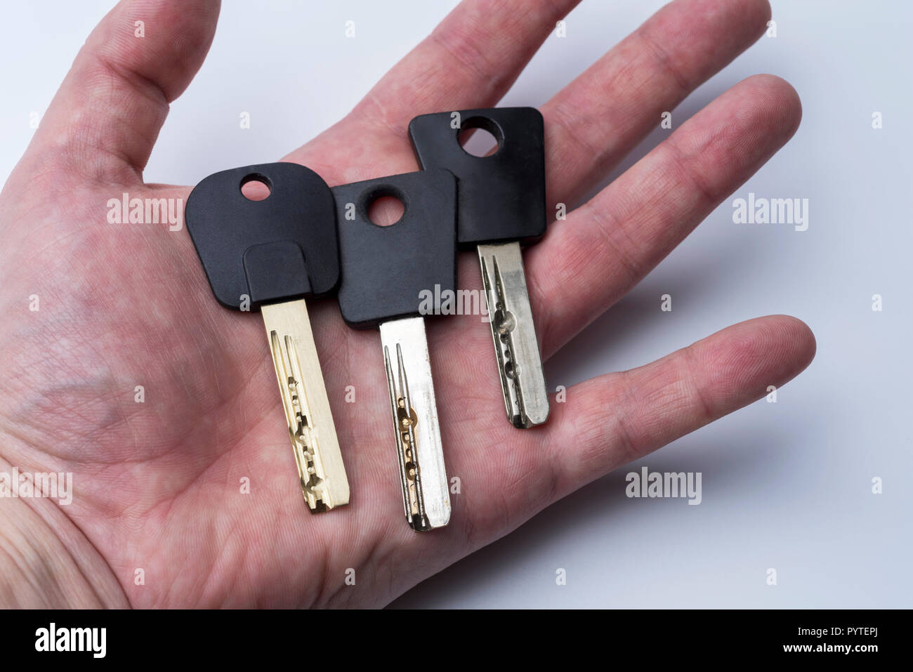 Set Of Keys On Human Palm Isolated On White Background. Three keys on ...