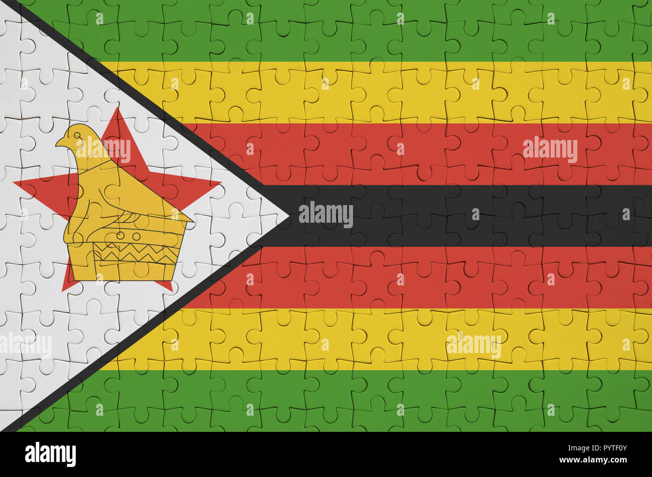 Zimbabwe flag is depicted on a folded puzzle Stock Photo - Alamy