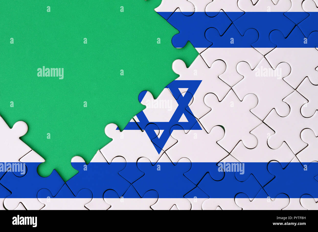 Israel flag is depicted on a completed jigsaw puzzle with free green ...