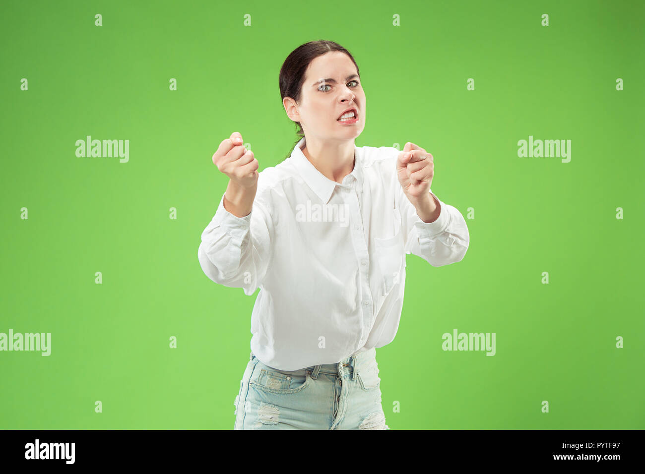 Angry woman looking at camera. Aggressive business woman standing ...