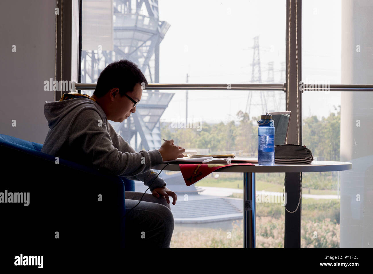 Male Chinese College Student Focusing in Library Studying Stock Photo ...