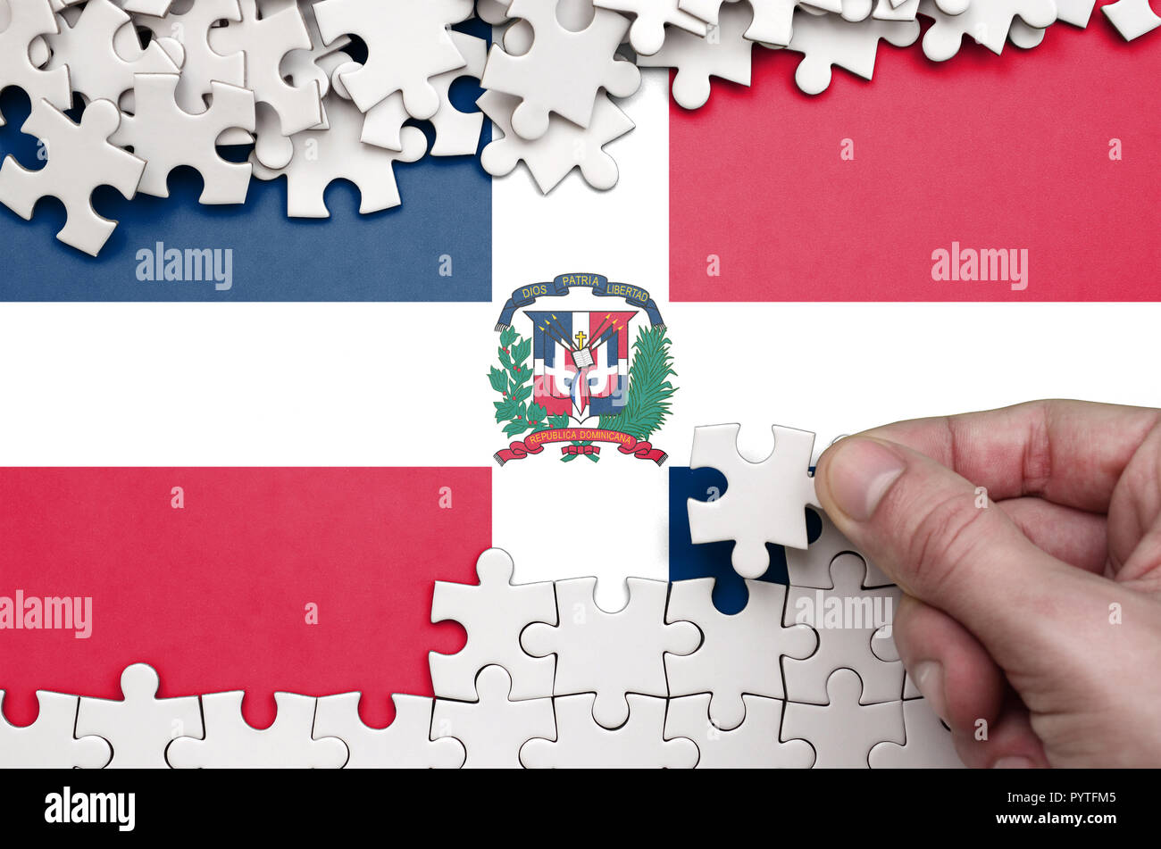 Dominican Republic flag is depicted on a table on which the human hand ...