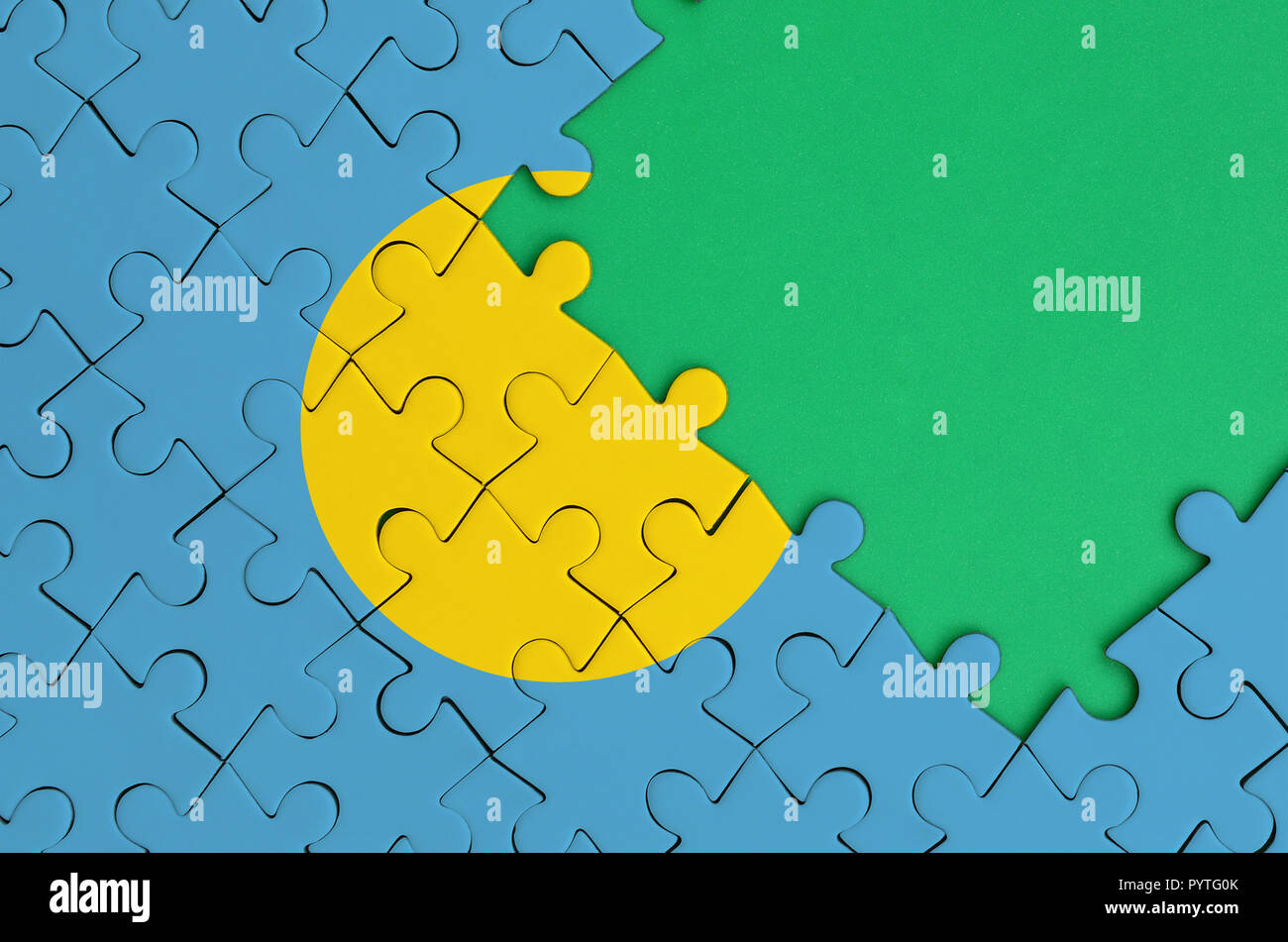 Palau flag is depicted on a completed jigsaw puzzle with free green ...